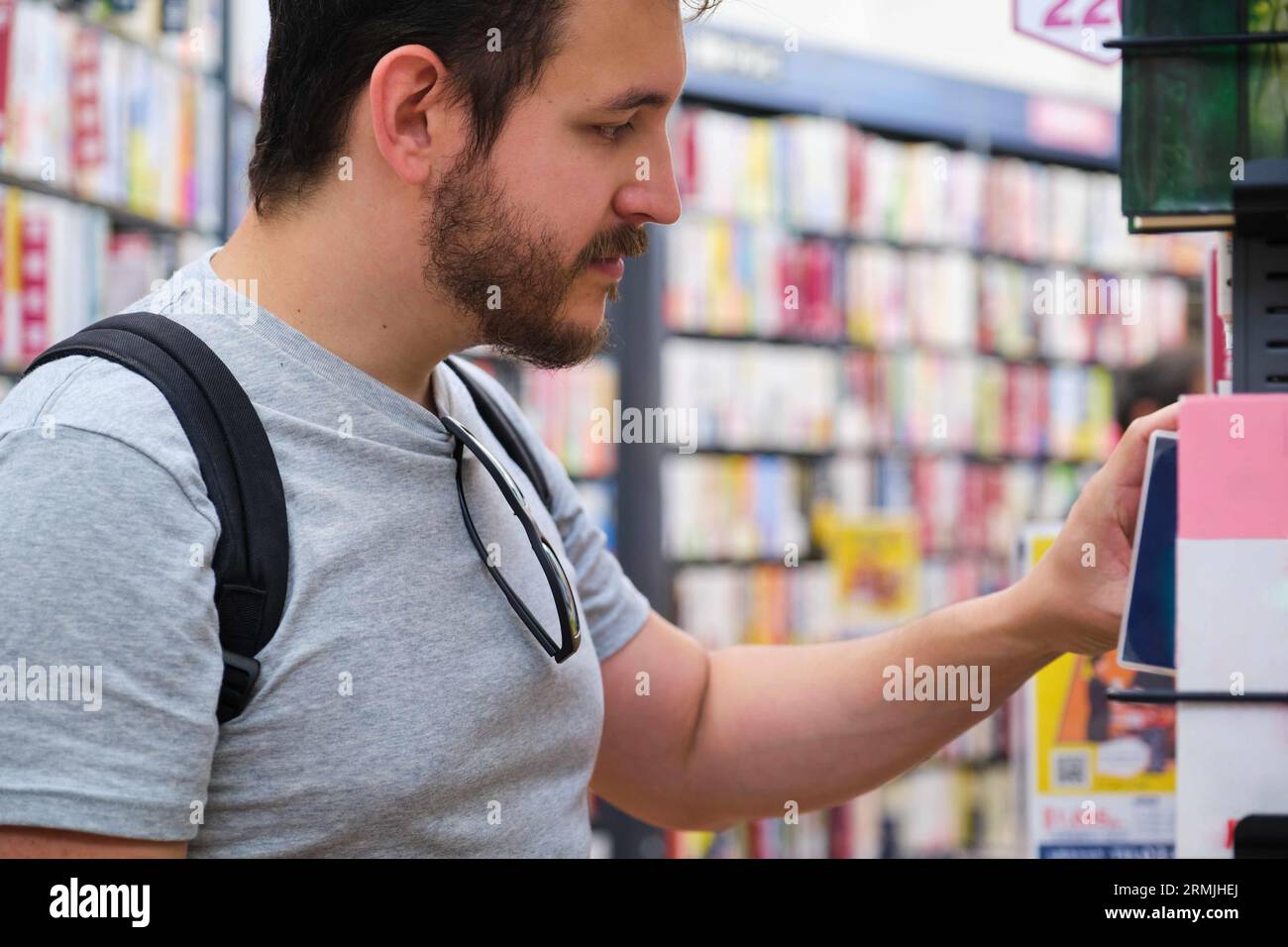 Latin tourist grab a comic at a Japanese comic book store in Tokyo ...