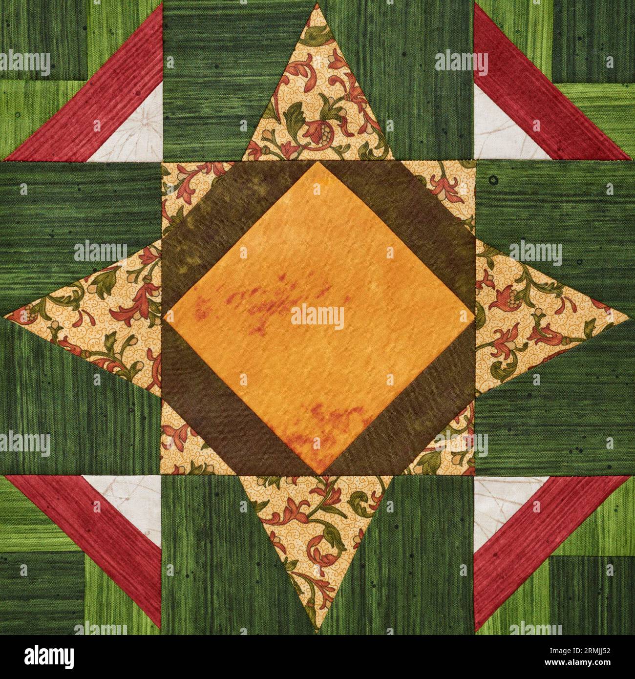 Bright orange-green geometric patchwork block from pieces of fabrics ...