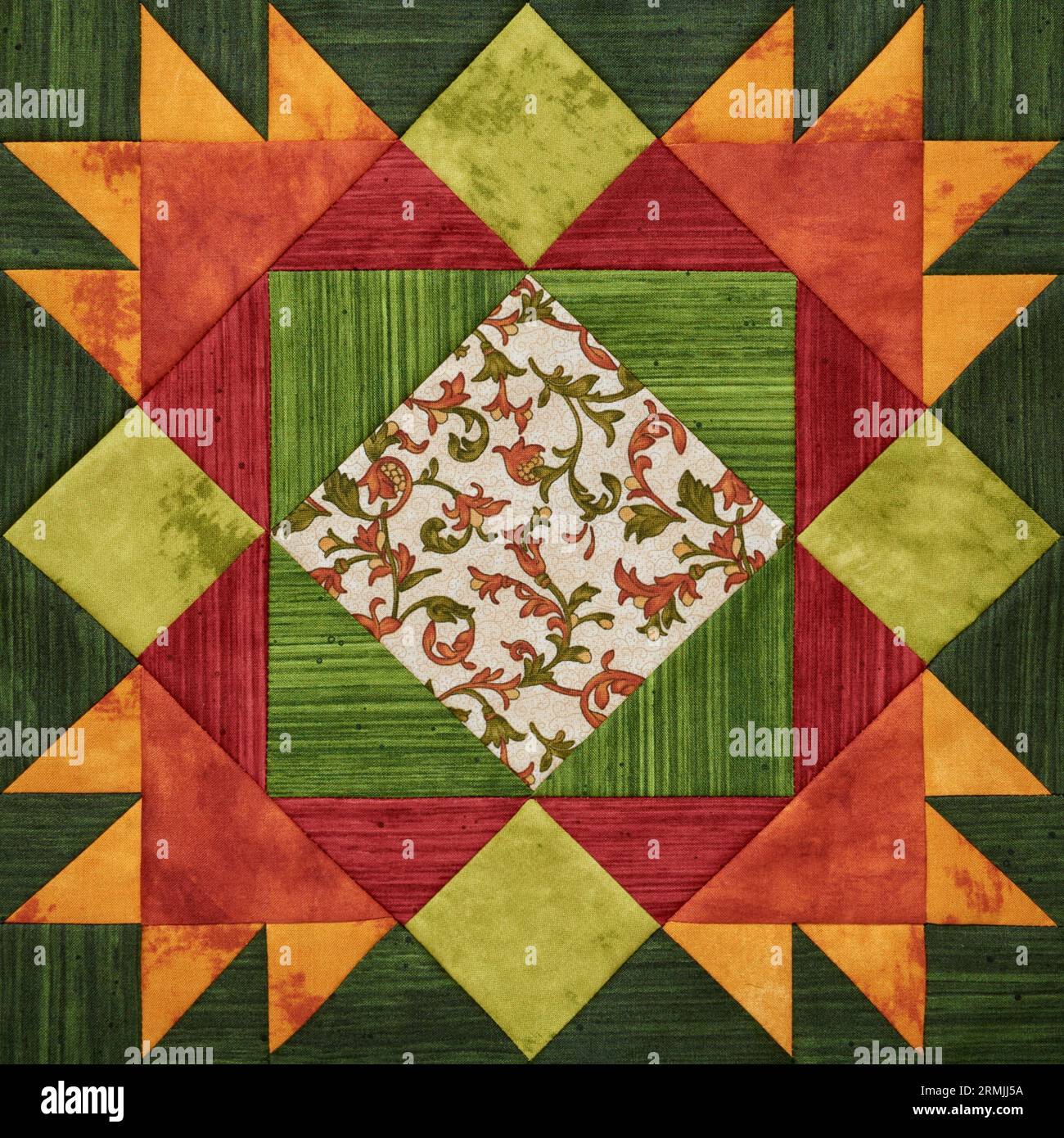 Bright orange-green geometric patchwork block from pieces of fabrics ...