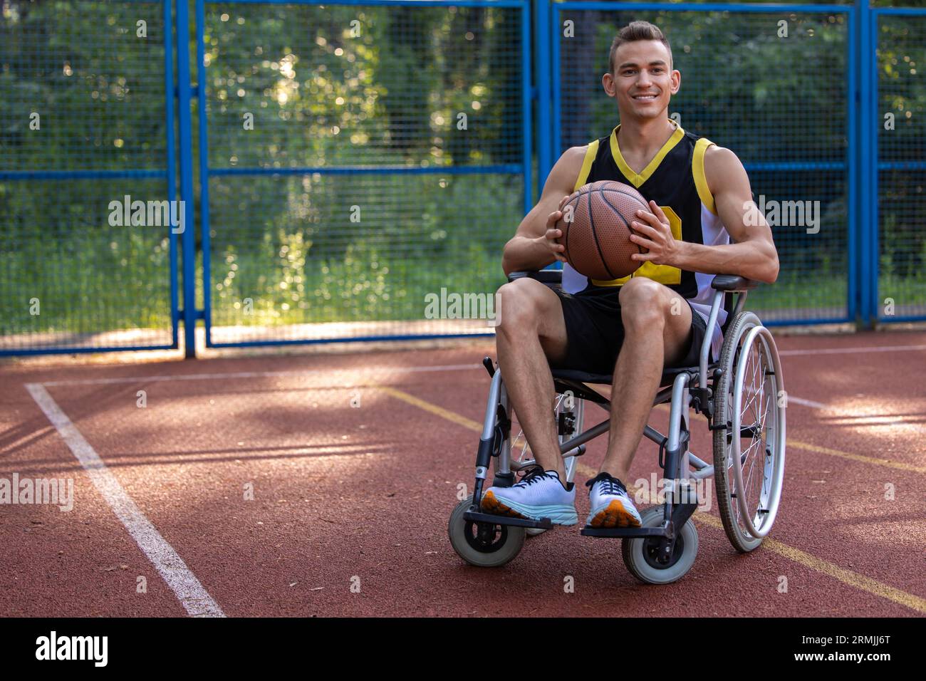 Wheelchair basketball player holding, disability, outdoor basketball ...