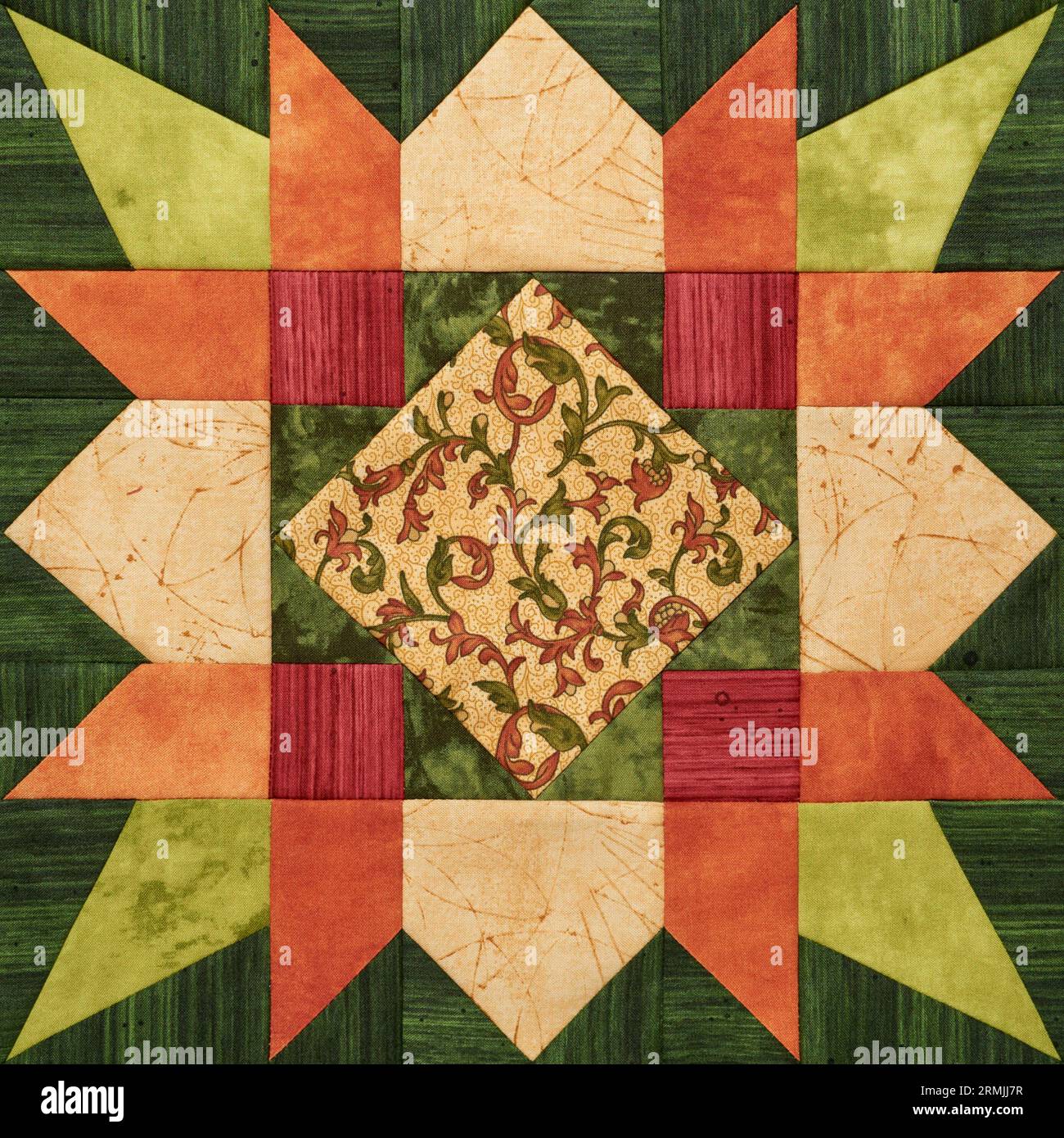 Bright orange-green geometric patchwork block from pieces of fabrics ...