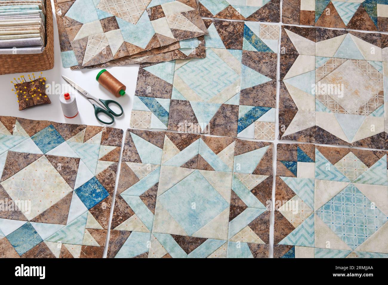 Assembling of quilt from patchwork blocks, a basket with fabric, sewing ...