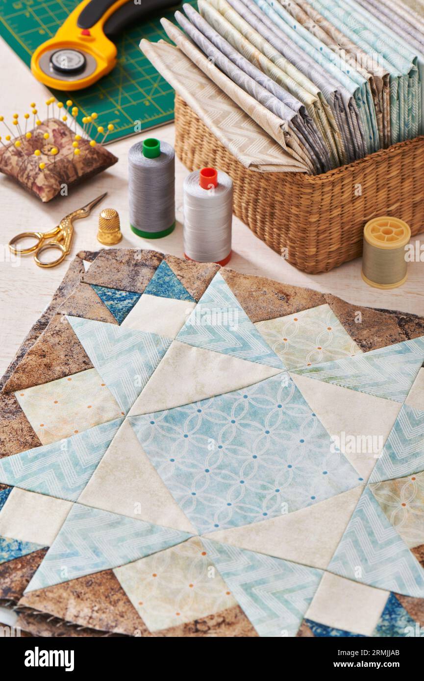 Prepared blocks for sewing quilt, stack of fabrics, sew accessories ...