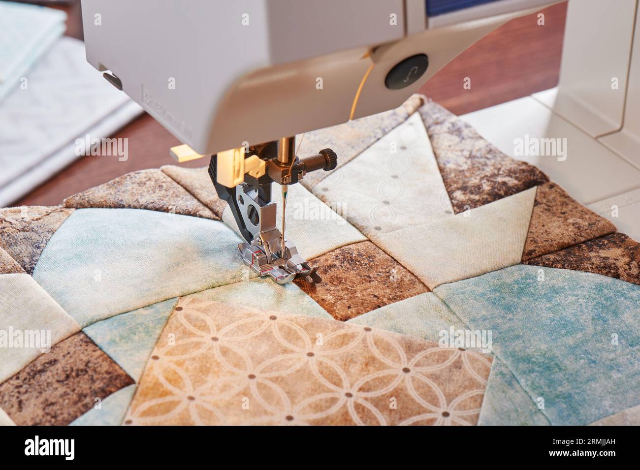 Modern sewing machine working on a patchwork block of quilt Stock Photo ...