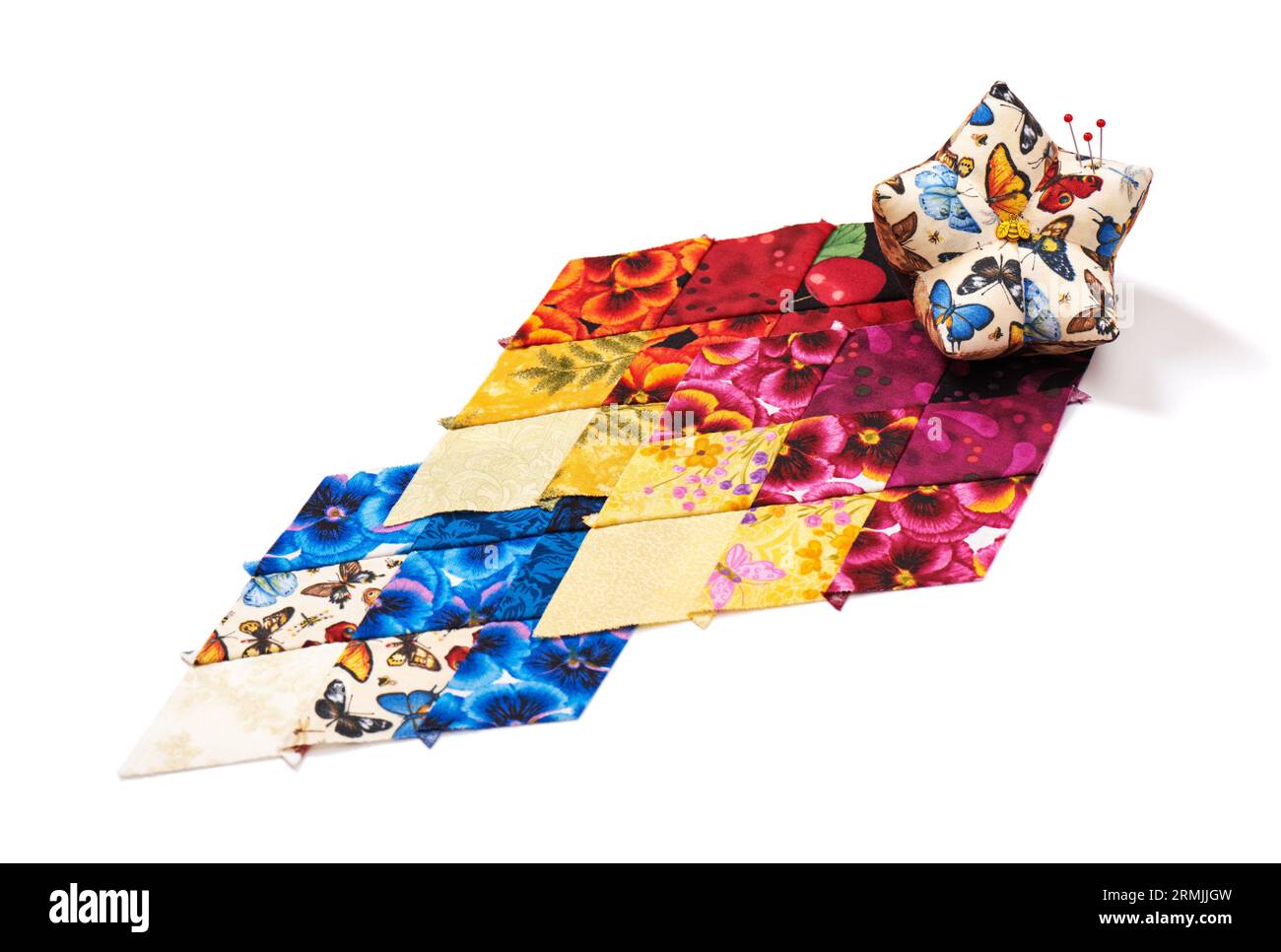 The diamond-shaped blocks and pin cushion laid out in the form of a ...