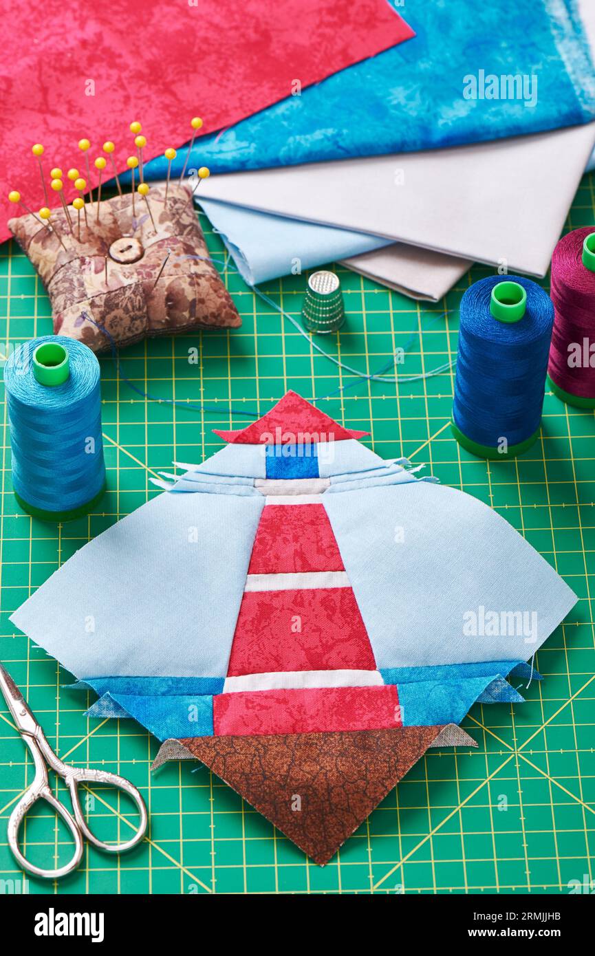 Sewing patchwork of block of lighthouse surrounded by accessories Stock ...