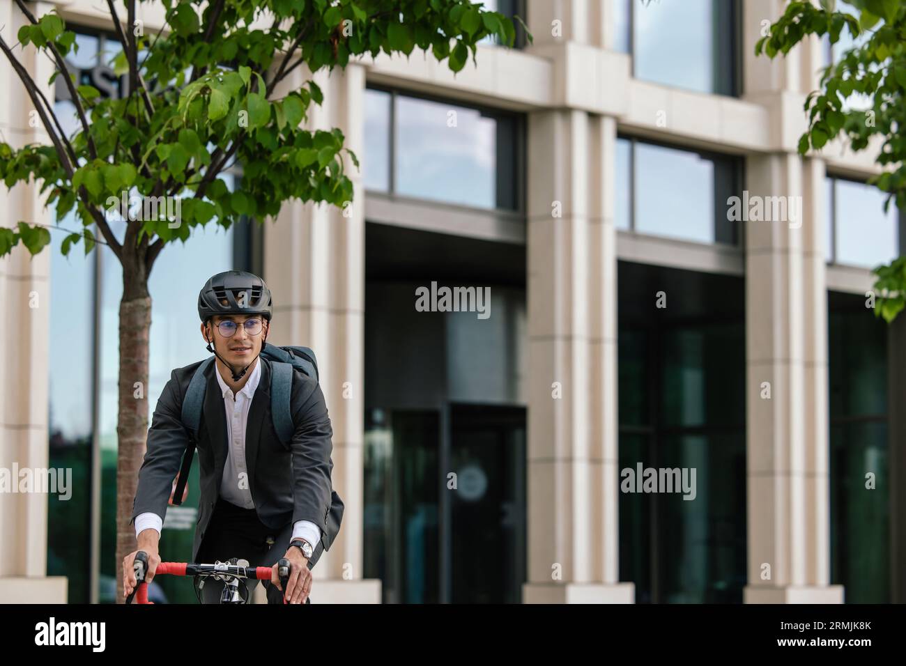 Man riding a bike in the office area Stock Photo - Alamy