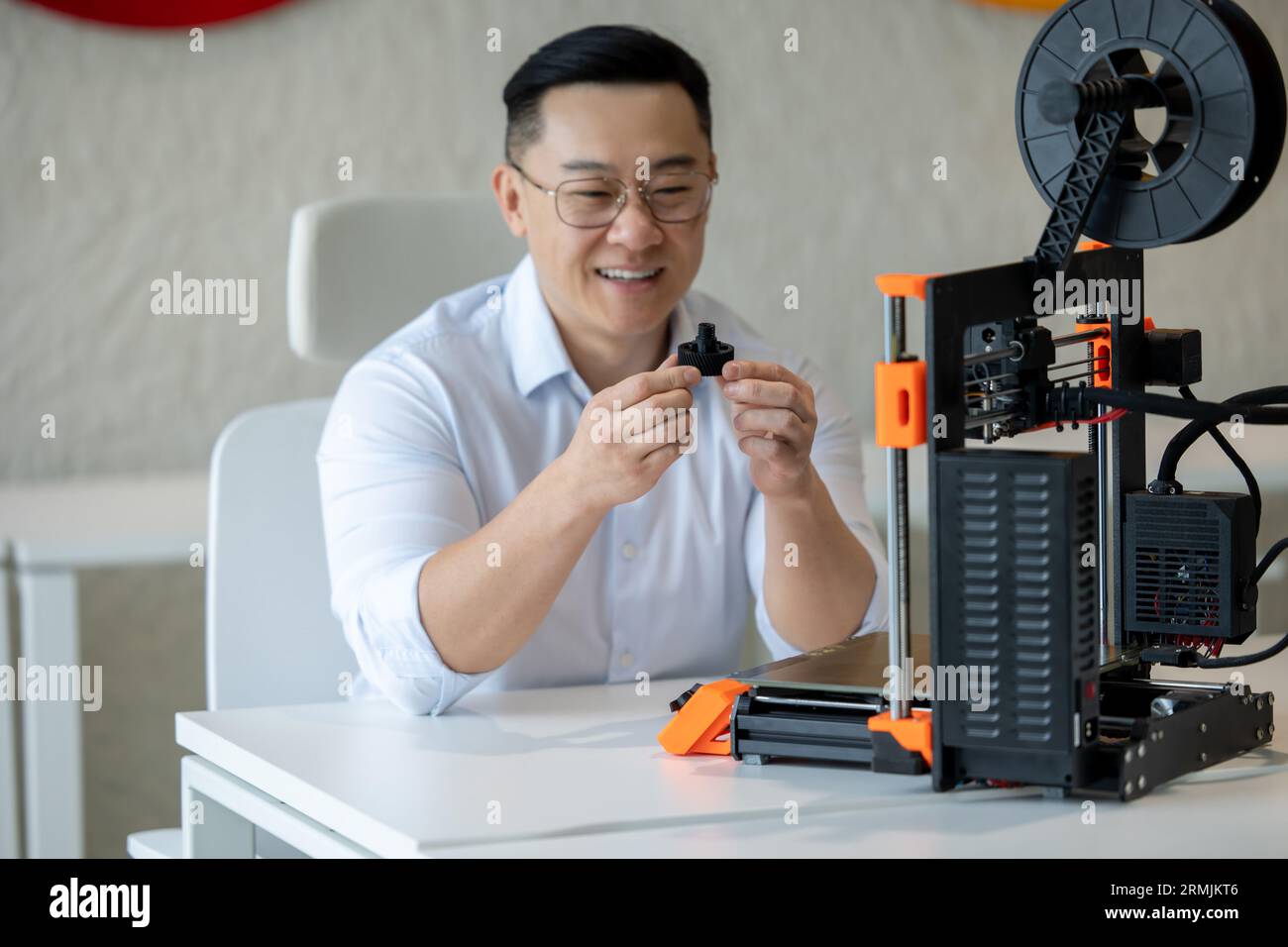 Male designer using 3D printer in office, working with new technology ...