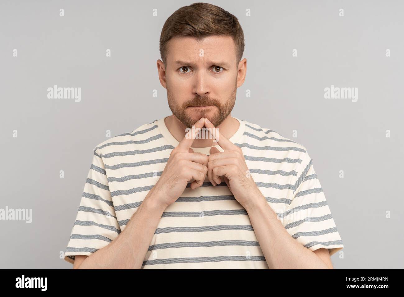 Agitated anxious man thinking about difficult problems looking at ...