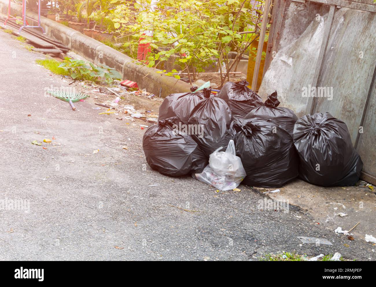 pile of garbage black bag roadside in city Stock Photo - Alamy