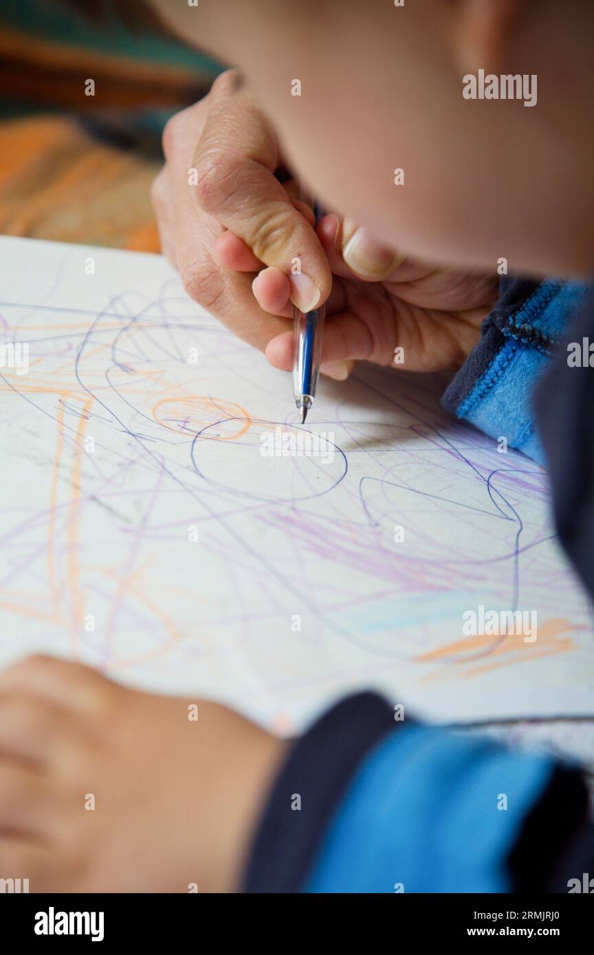 Close up of young boy drawing with color pencil Stock Photo - Alamy