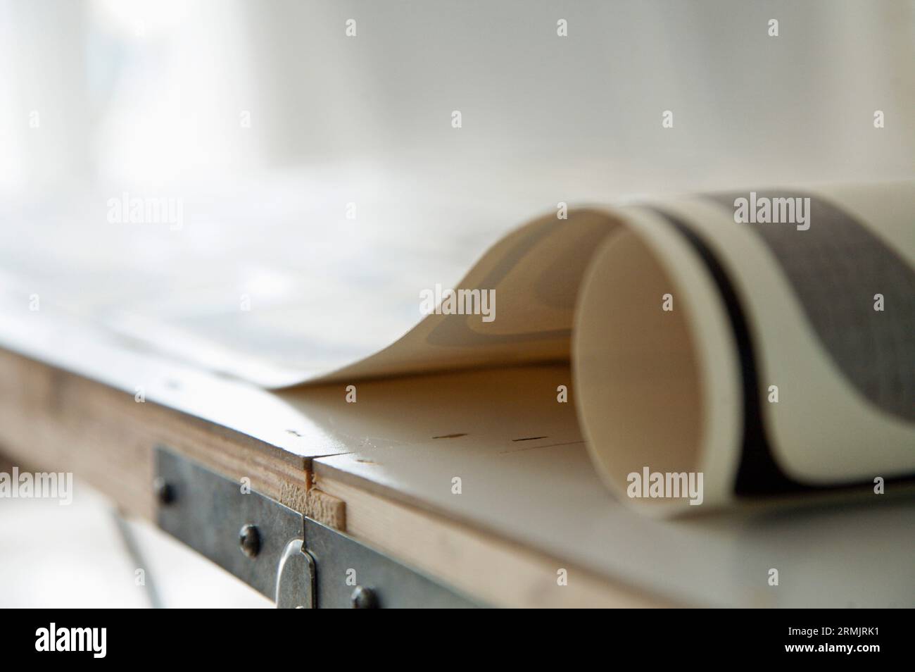 Wallpaper roll on wallpaper table Stock Photo - Alamy