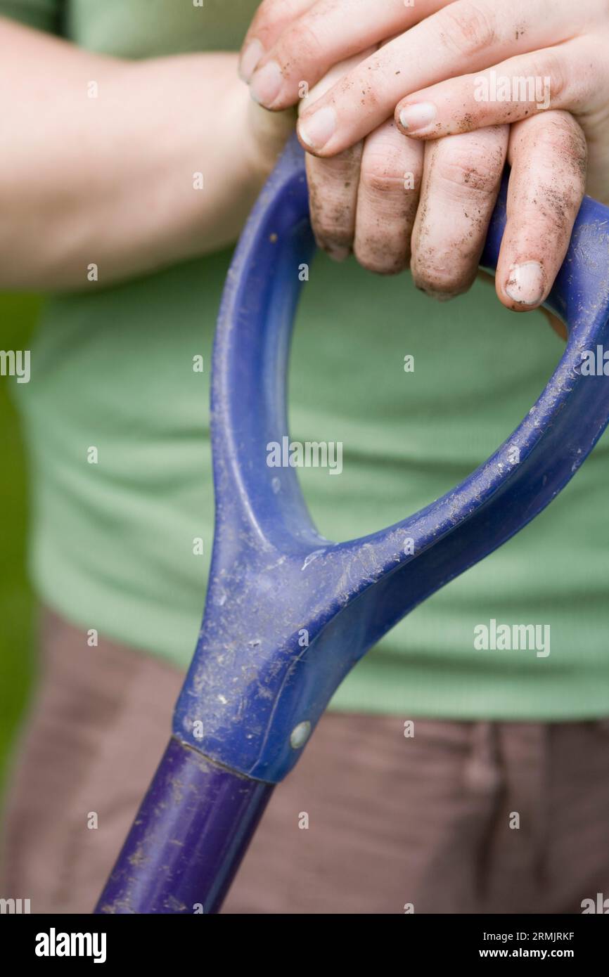 Extreme close up of hands on garden tool handle Stock Photo - Alamy