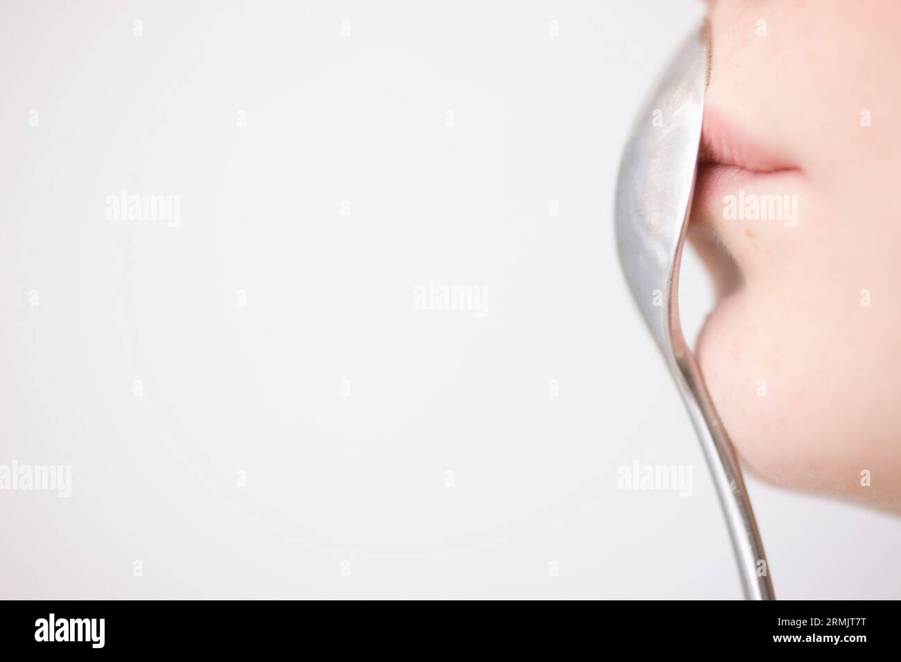 Spoon in mouth adult hi-res stock photography and images - Alamy