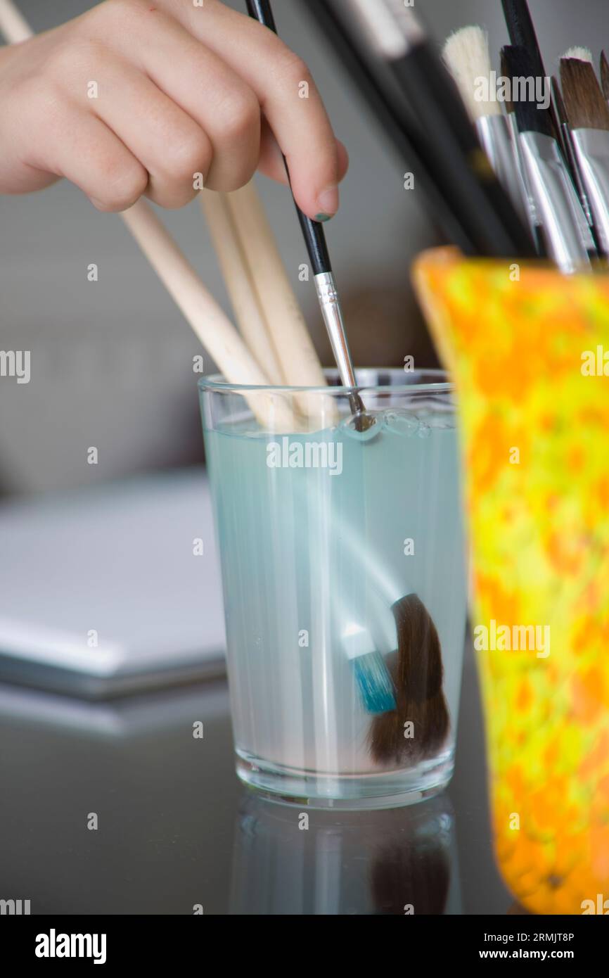 Paintbrush in jar of water painting hi-res stock photography and images ...