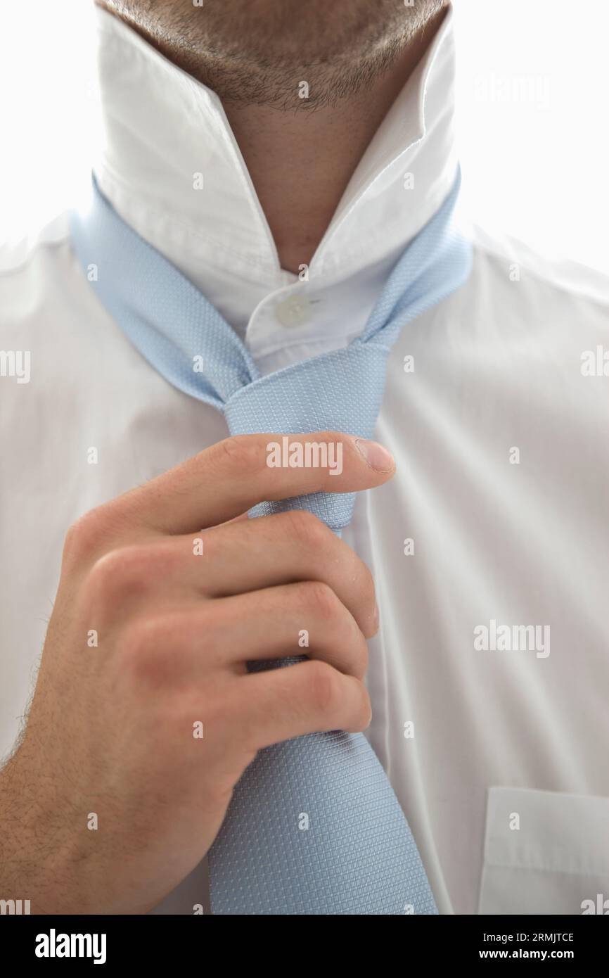Man straightening his tie hi-res stock photography and images - Alamy