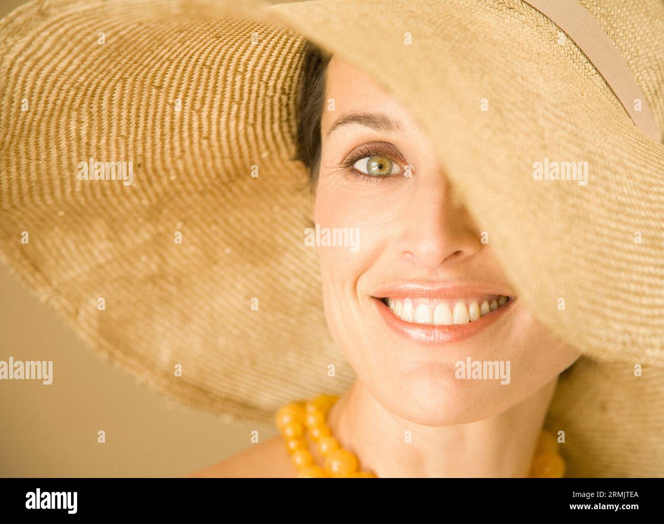 Woman wearing straw hat Stock Photo - Alamy