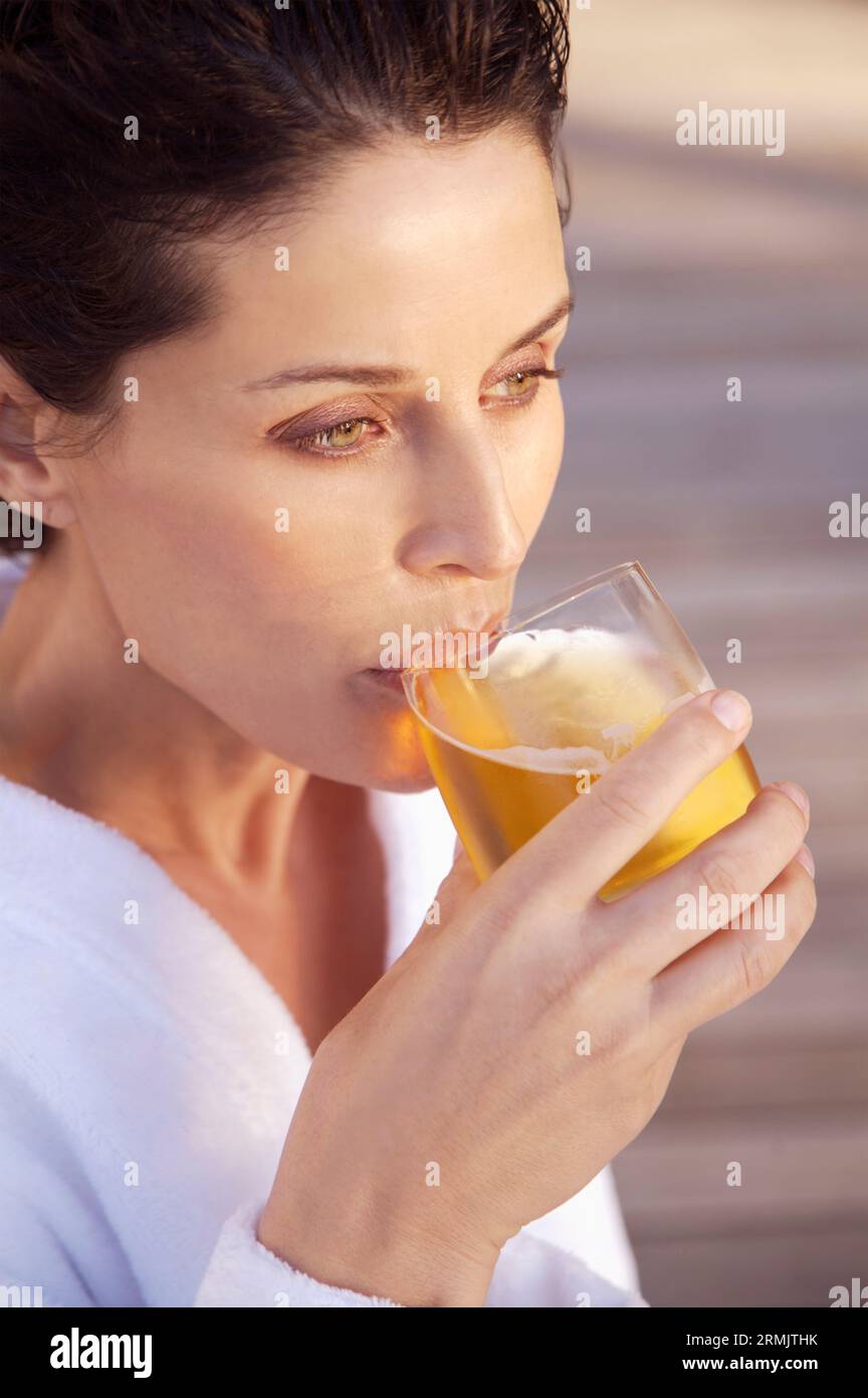 Woman drinking apple juice Stock Photo - Alamy