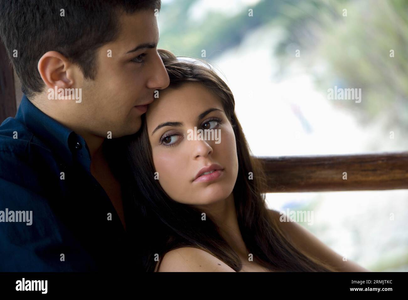 Portrait of young couple snuggling Stock Photo - Alamy