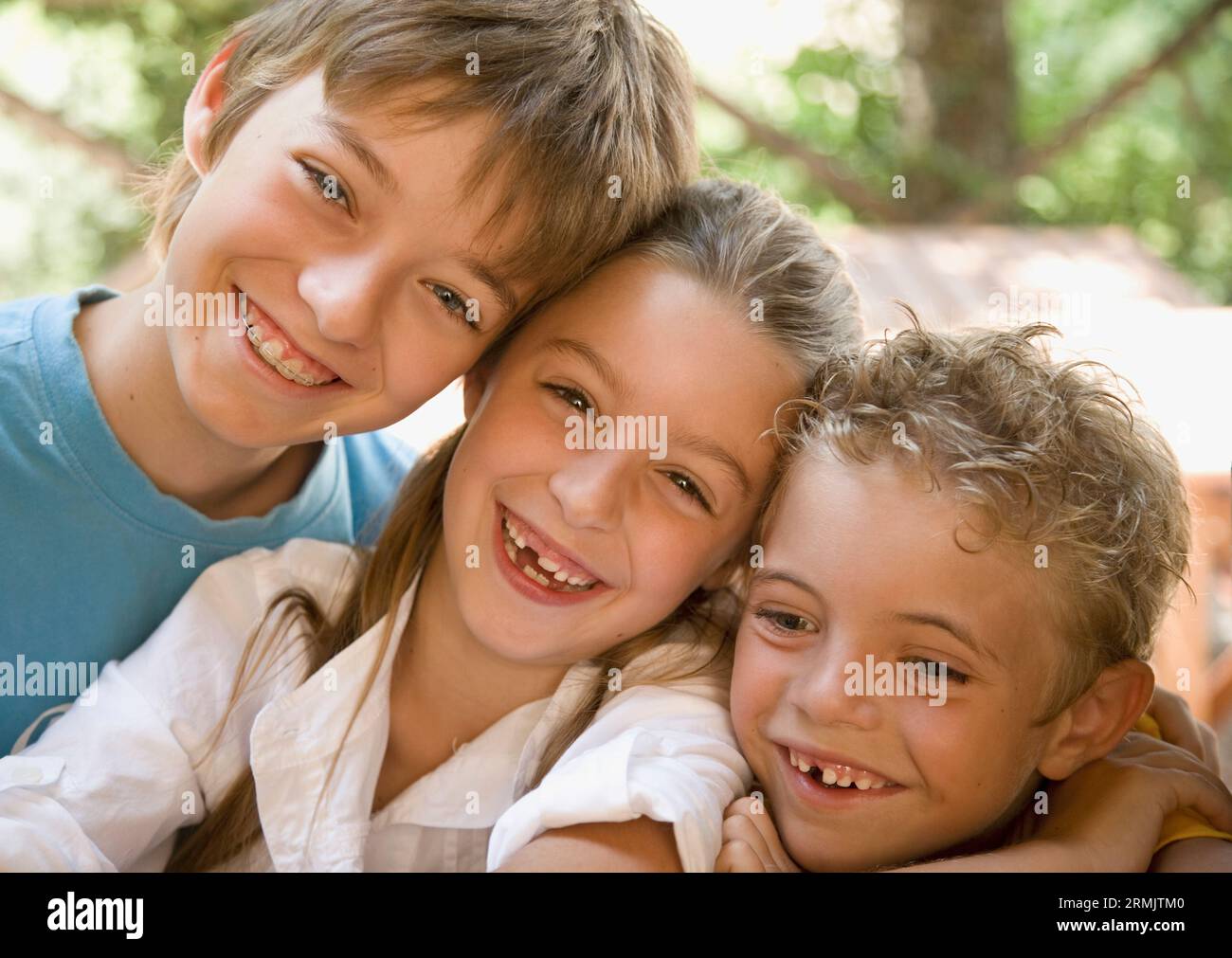 Portrait of three young children laughing Stock Photo - Alamy