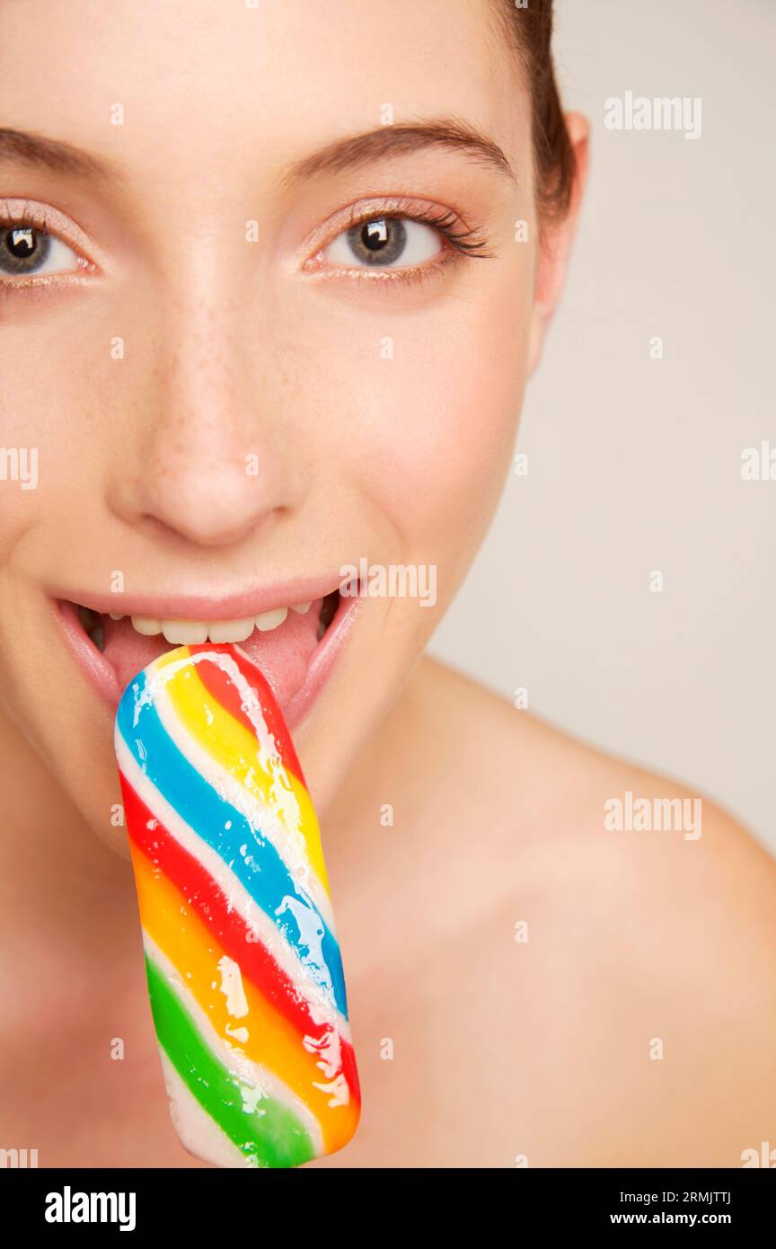 Young woman licking popsicle hi-res stock photography and images - Alamy