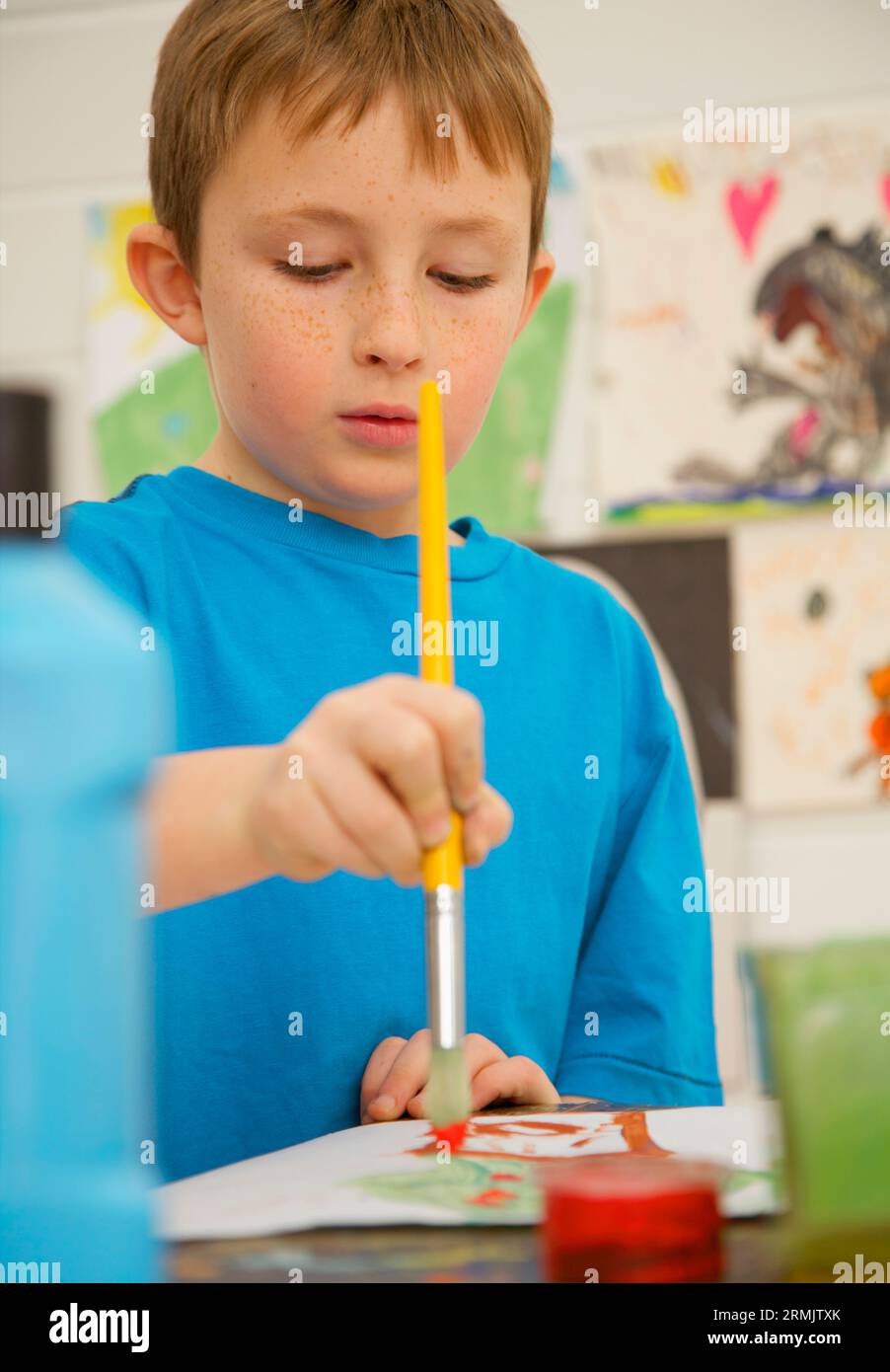 Portrait of young boy painting with watercolor Stock Photo - Alamy