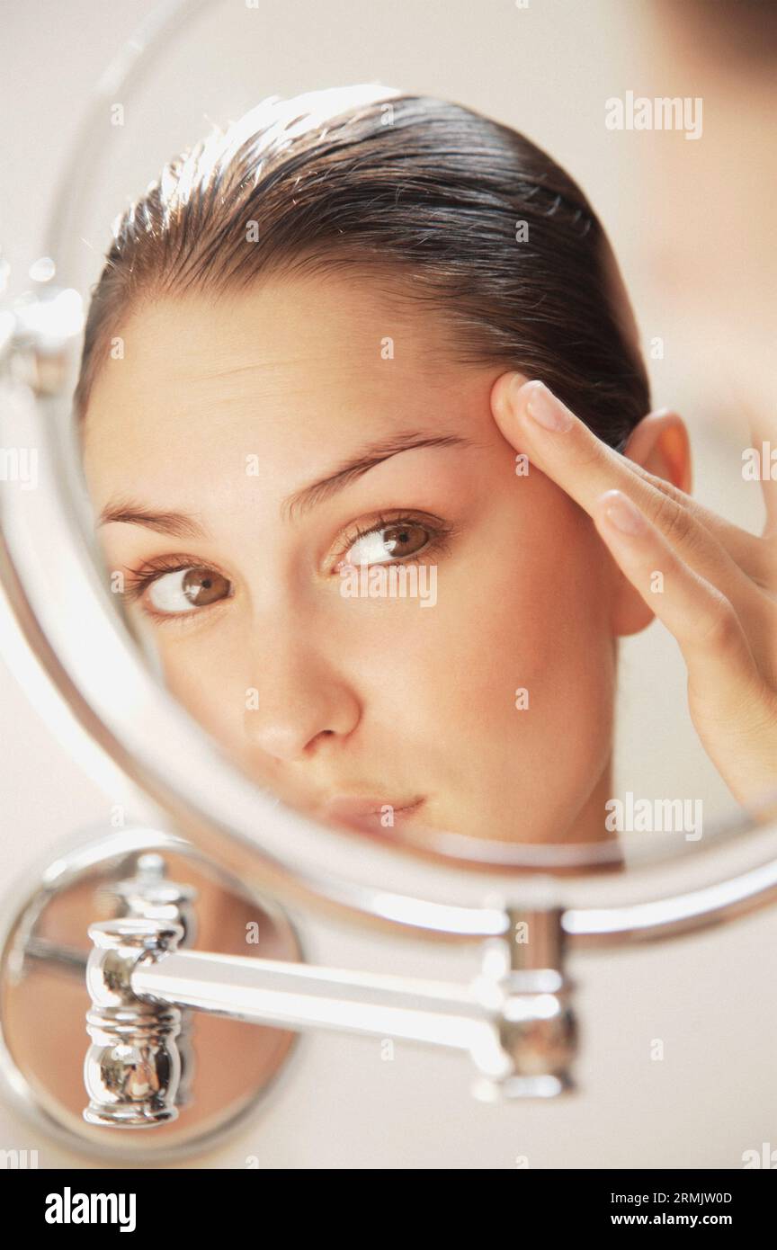 Woman pulling face in mirror hi-res stock photography and images - Alamy