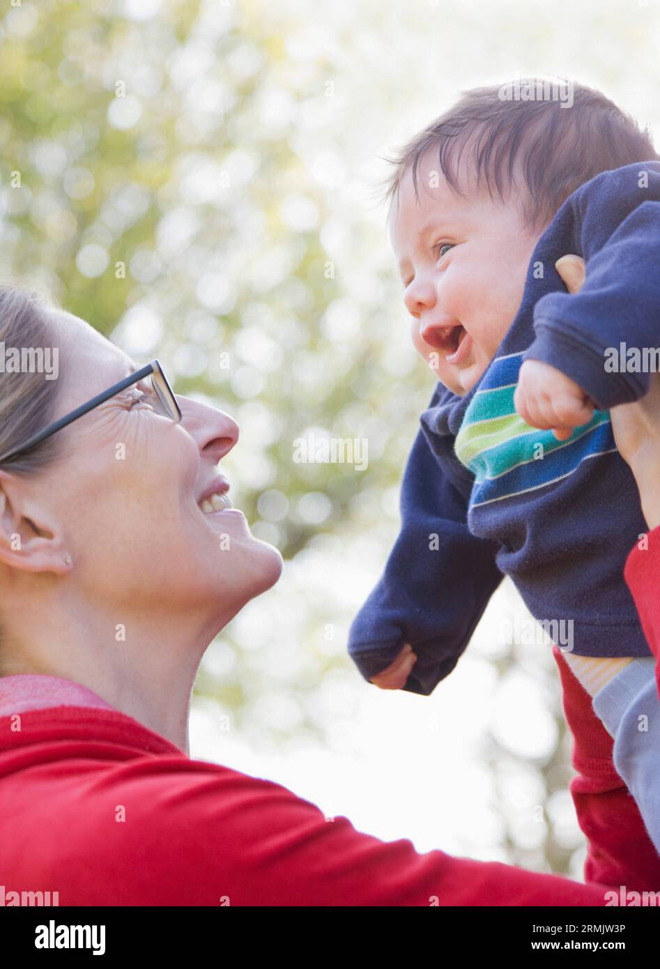 Mum lifting baby hi-res stock photography and images - Alamy