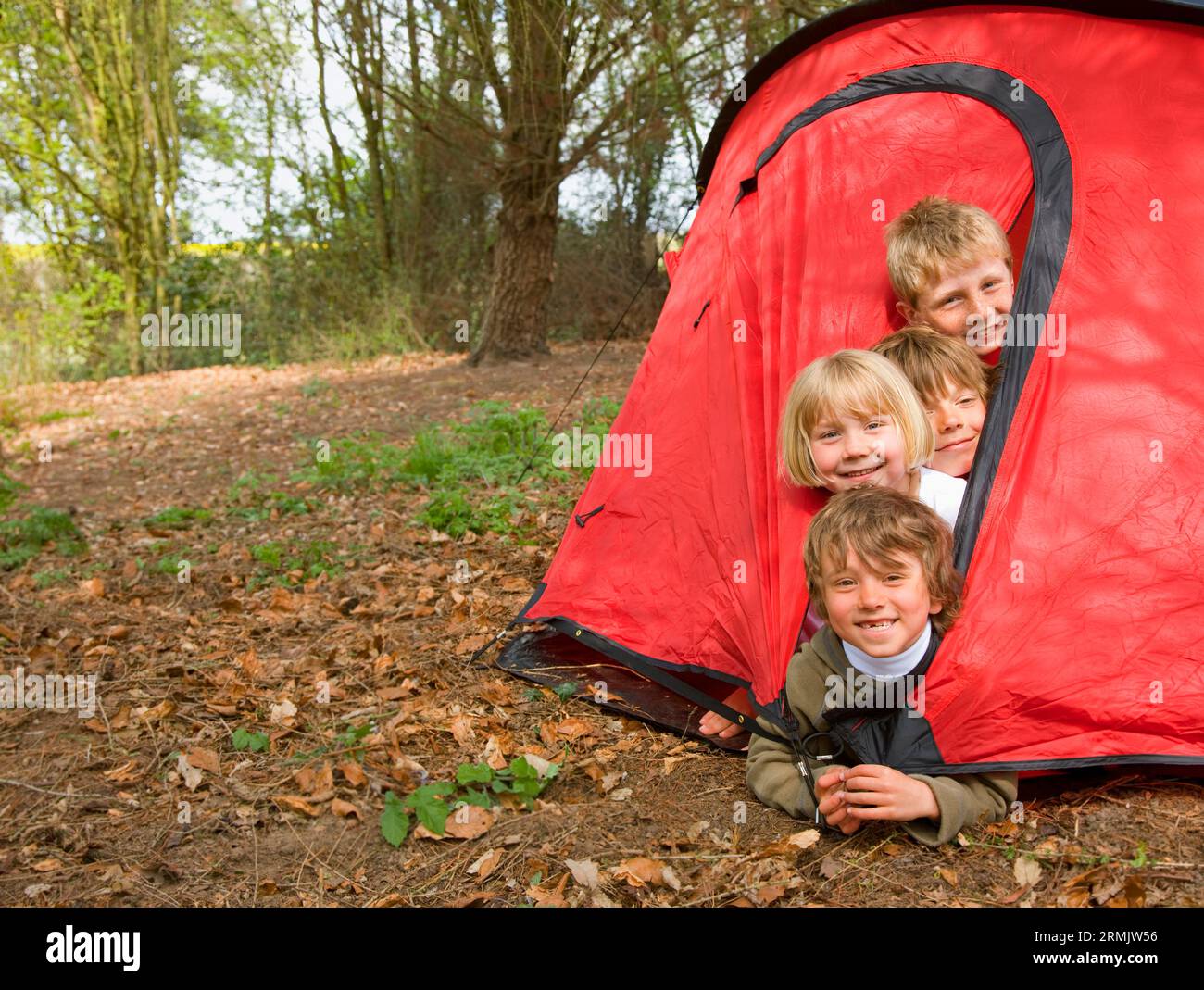 Portrait of children coming out of tent opening Stock Photo - Alamy
