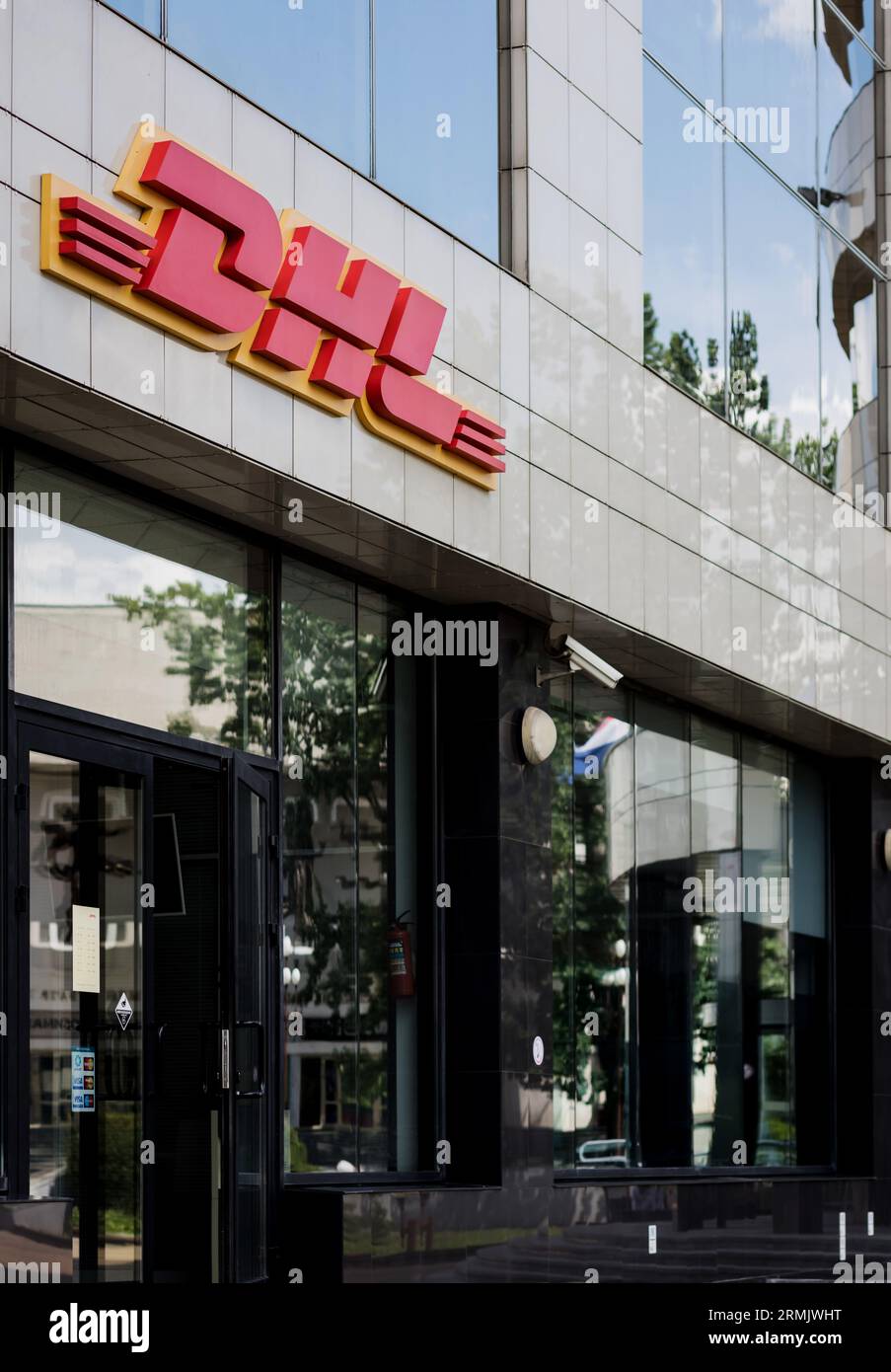Minsk, Belarus, August 2023 - facade of the building with a DHL sign ...