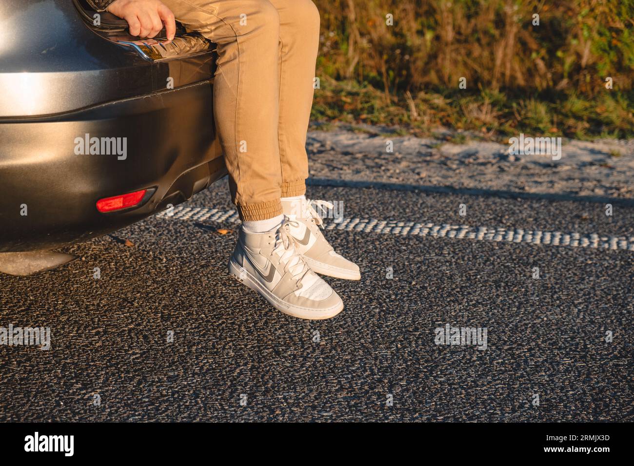 The trunk of a car is full of man whose legs are sticking out. Taking a ...
