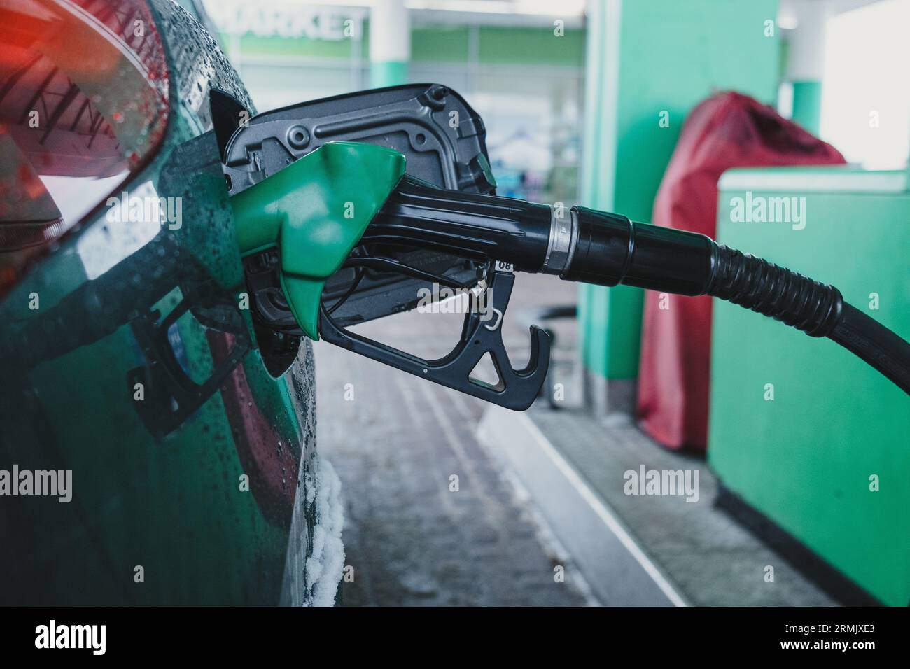 Gas pump nozzle in the fuel tank of a car Stock Photo - Alamy