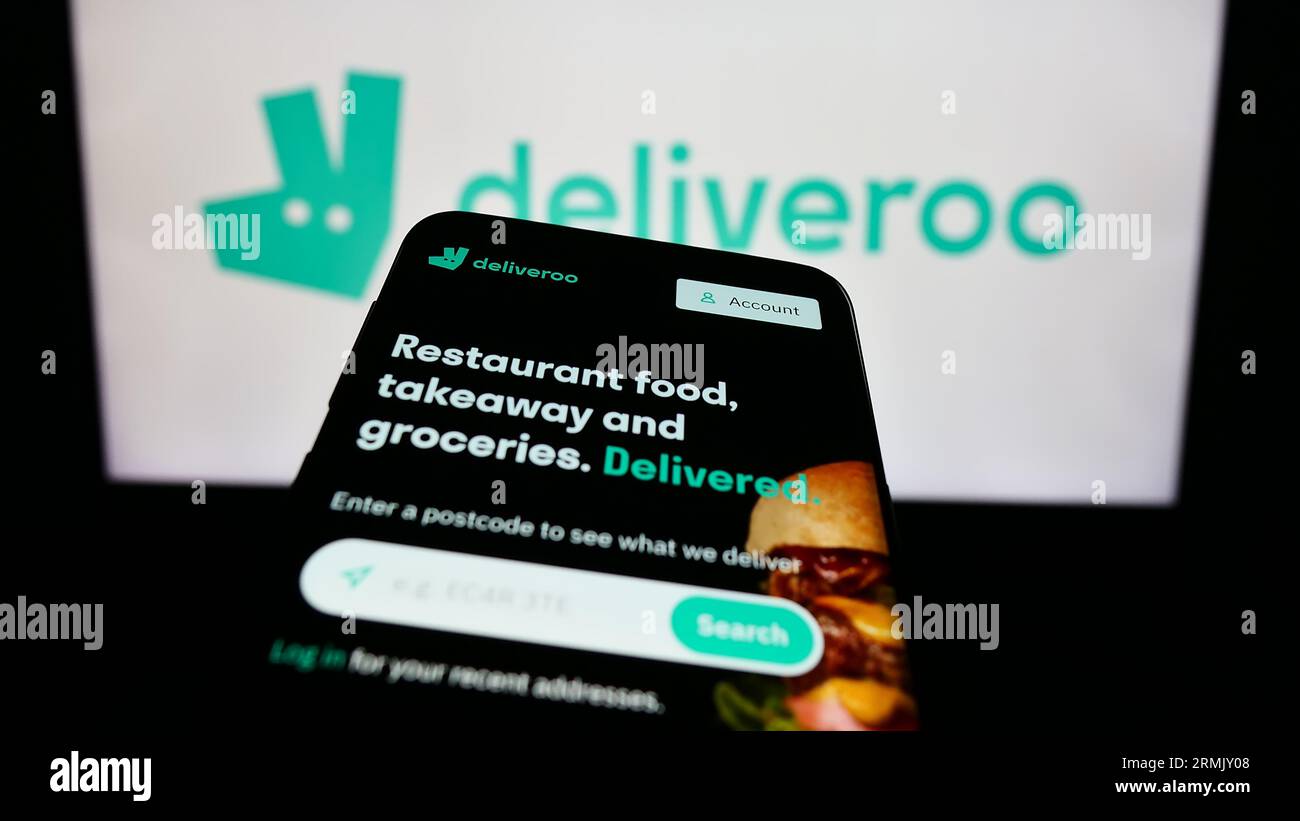 Mobile phone with website of food delivery company Deliveroo Holdings ...