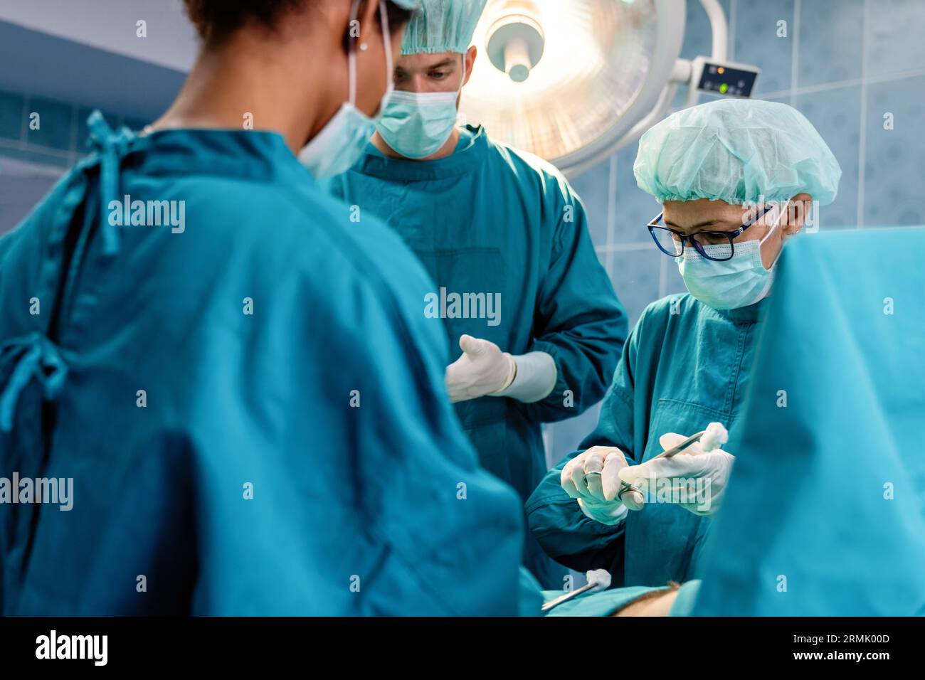 Successful team of surgeon standing in operating room, ready to work on ...