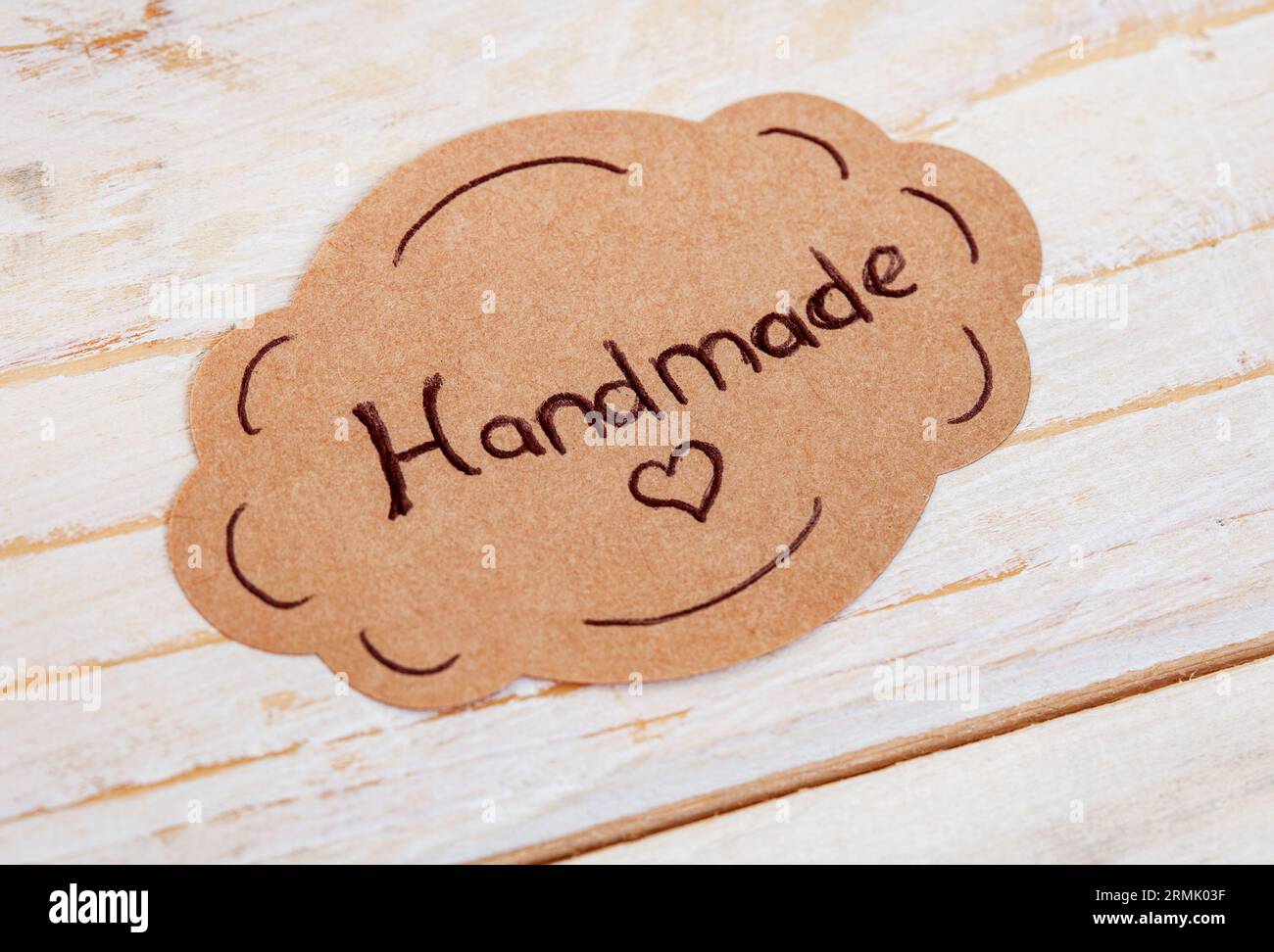 Handmade written on vintage label on rustic wood with selective focus ...