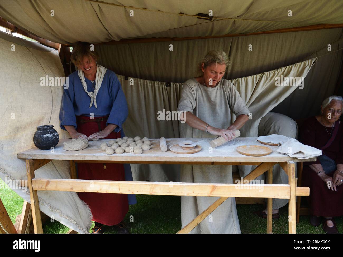 Viking women baking traditional bread at the Viking annual festival in ...
