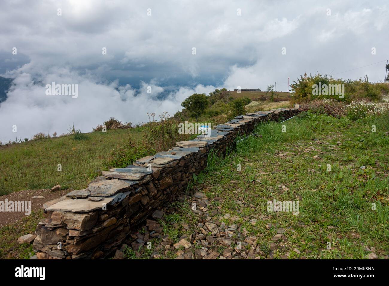 Rural stone wall amidst Himalayan mountains, Uttarakhand, India. Scenic ...