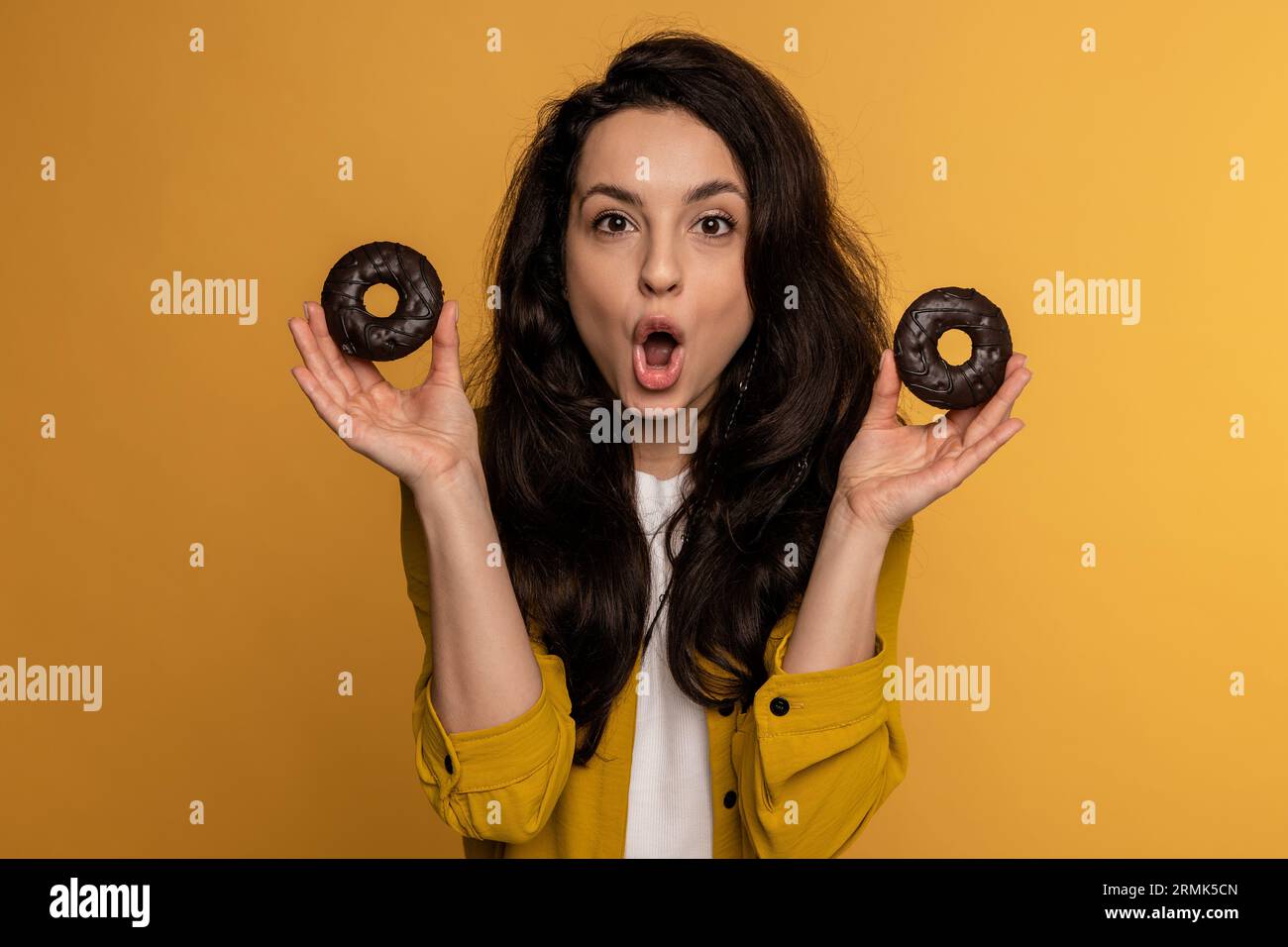 Cute brunette posing for the camera with delicious biscuits on the ...
