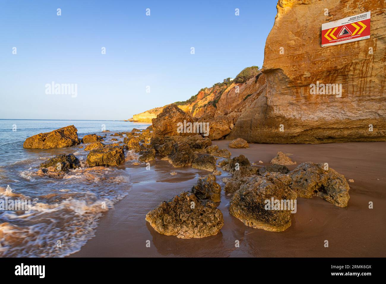 ROCKFALL UNSTABLE CLIFFS, KEEP A SAFE DISTANCE is written in English on ...