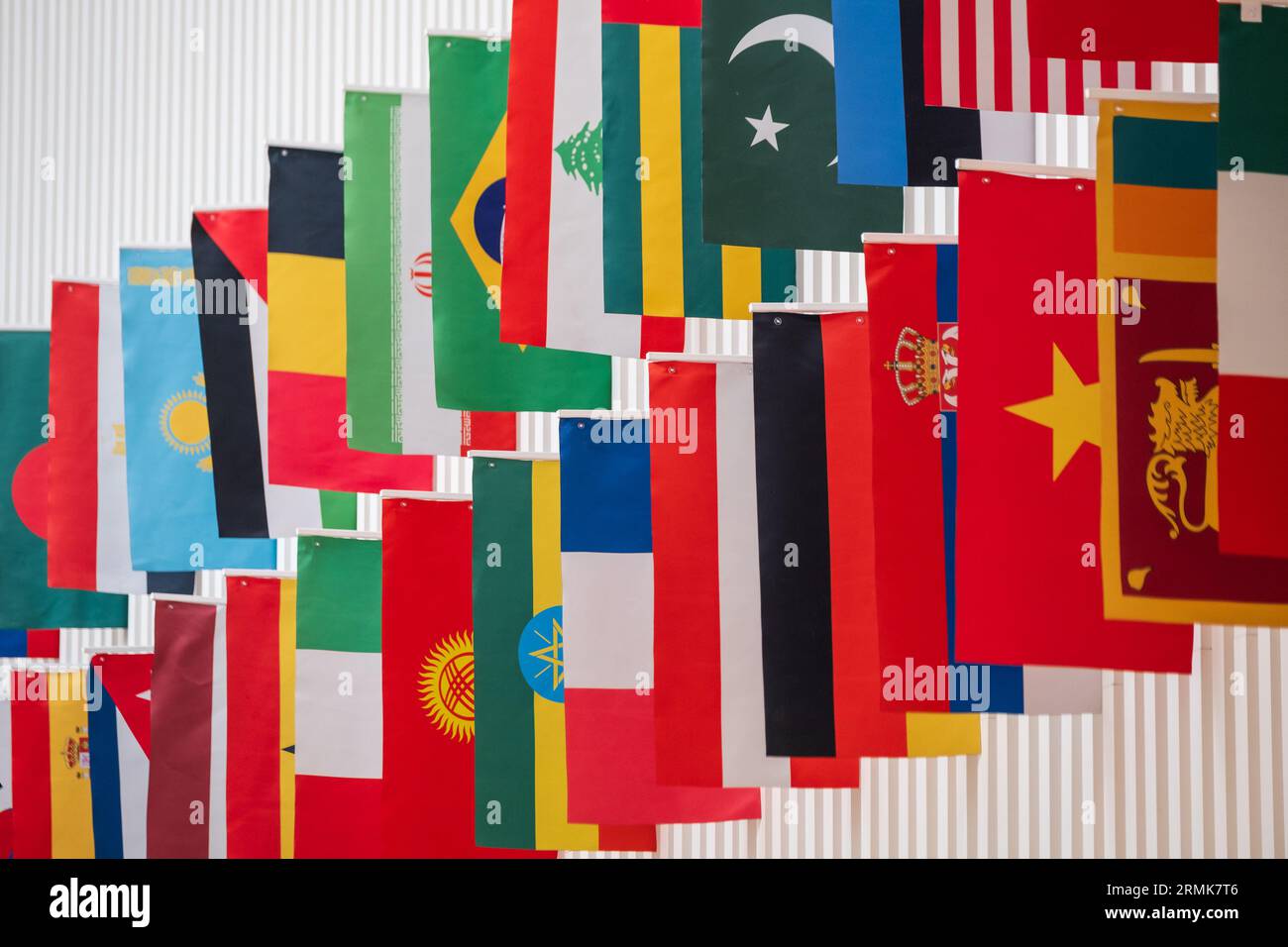Colorful national flags of various countries hanging in row on street ...
