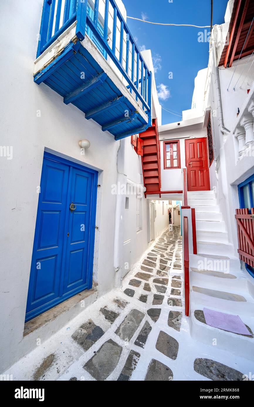 Cycladic white houses with colourful doors and shutters, alleys of the ...