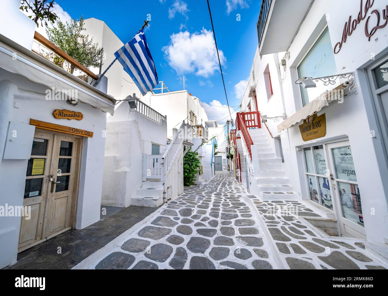 Cycladic white houses with colourful doors and shutters, alleys of the ...