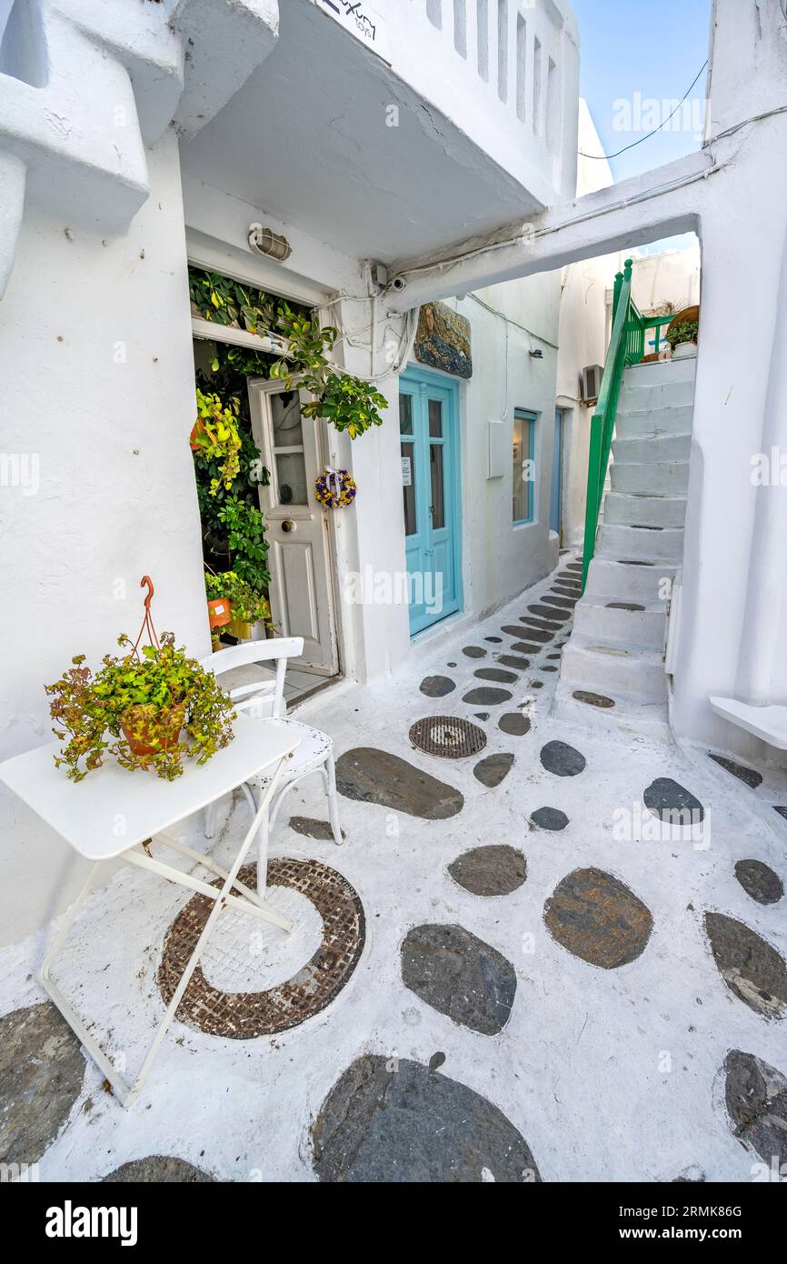 Cycladic white houses with colourful doors and shutters, alleys of the ...
