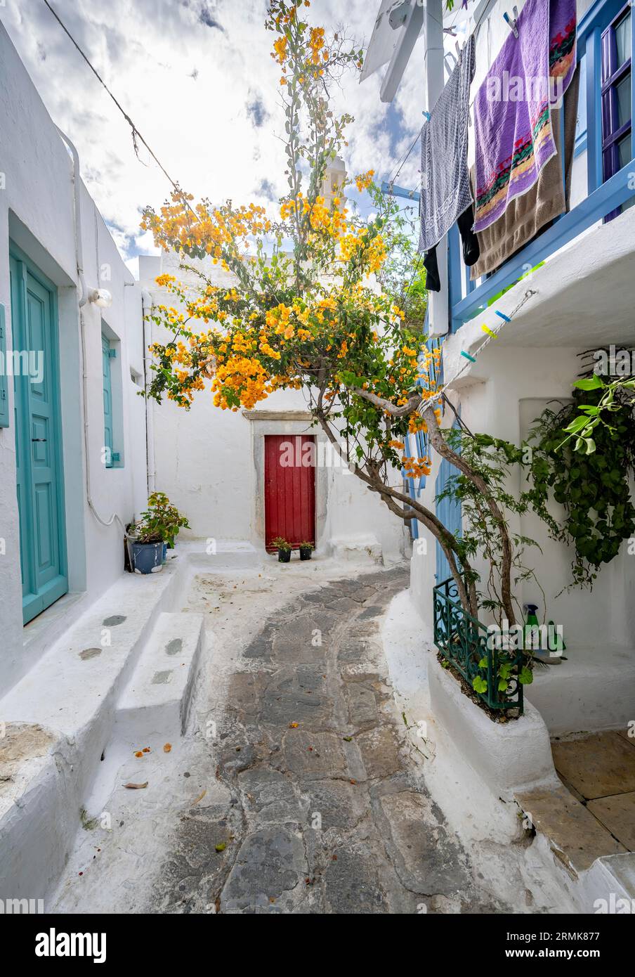 White Cycladic houses with colourful shutters and doors and yellow ...