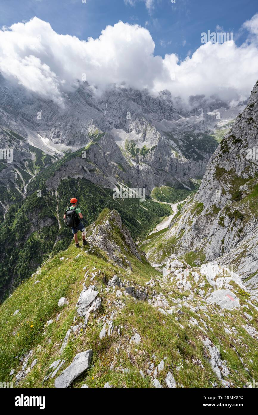 Climbers in steep terrain on the way to Waxenstein, view of Hoellental ...