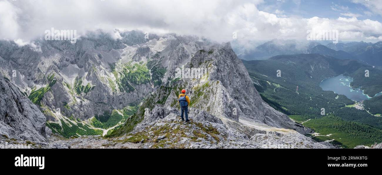 Panorama, mountaineer at the summit of the Waxenstein, view over rocky ...