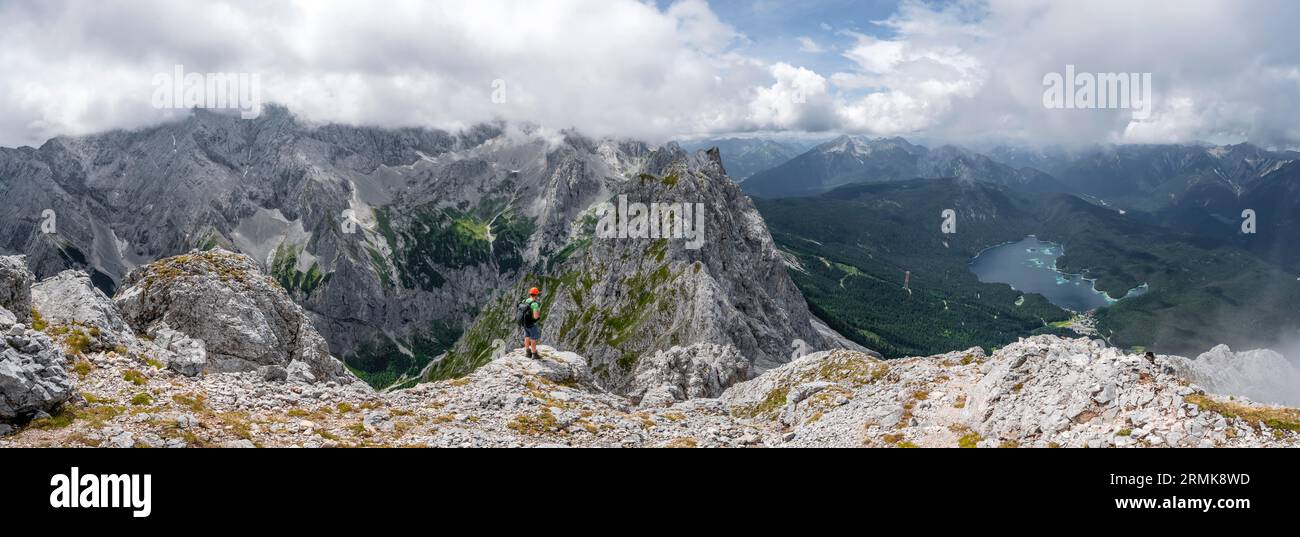 Panorama, mountaineer at the summit of the Waxenstein, view over rocky ...