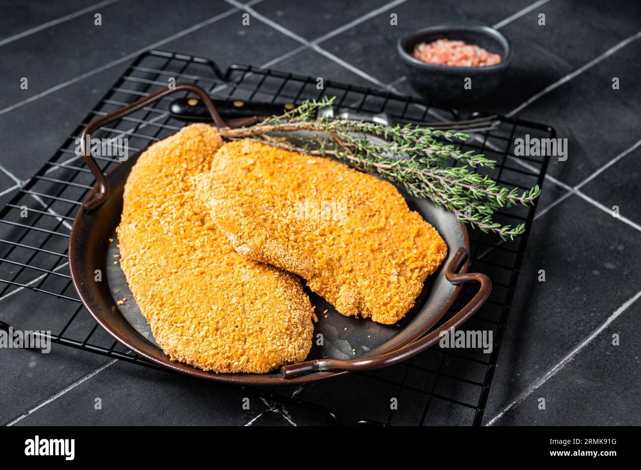 Homemade raw breaded German Weiner Schnitzel. Black background. Top ...