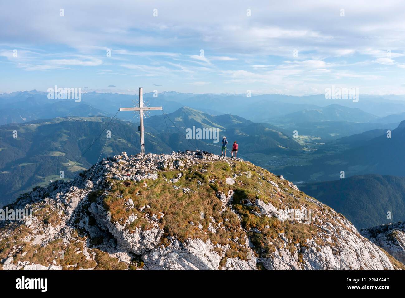 Two hikers at the summit, aerial view, evening mood in the mountains ...