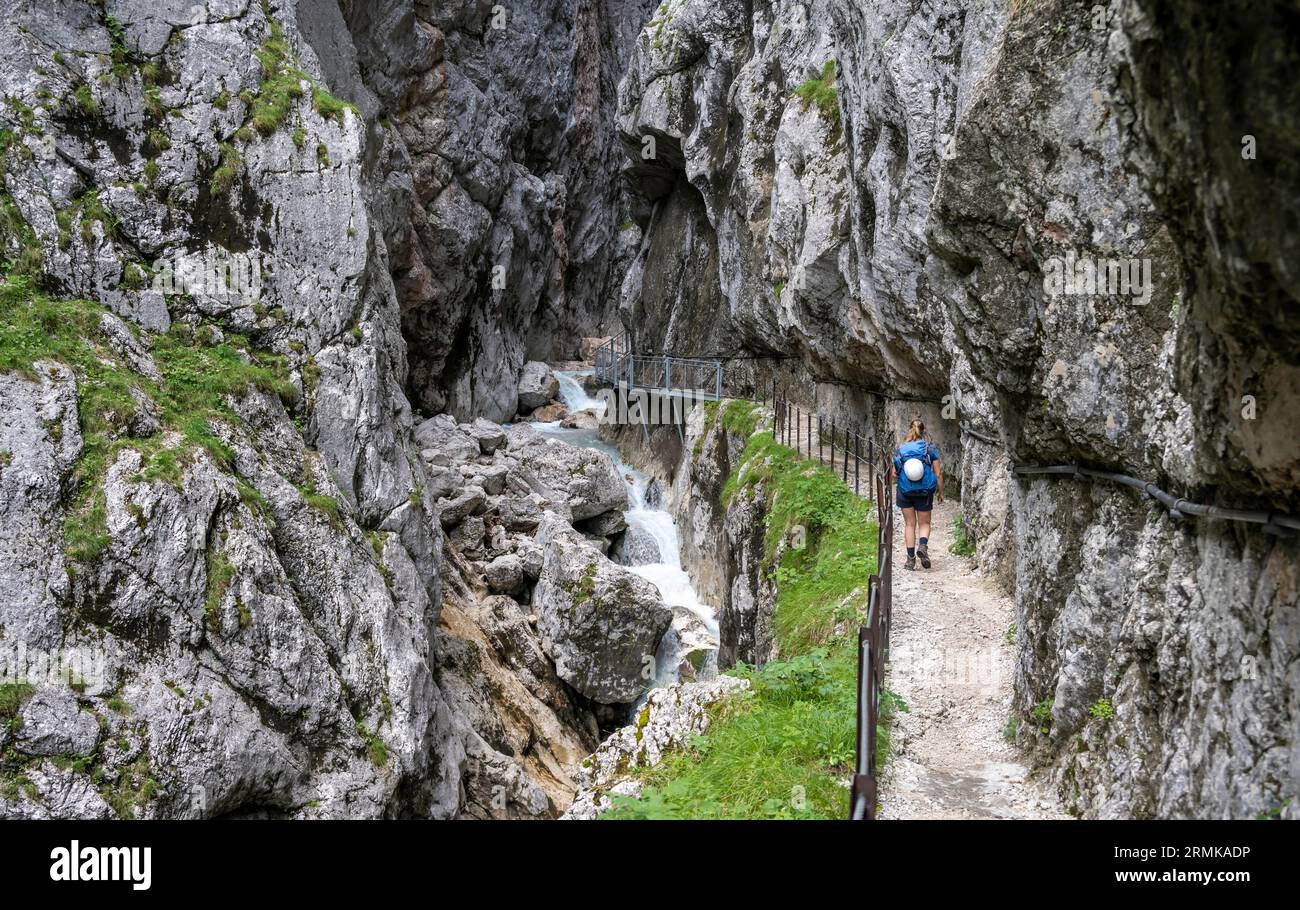 Hiker in a gorge, Hammersbach flows through Hoellentalklamm, near ...